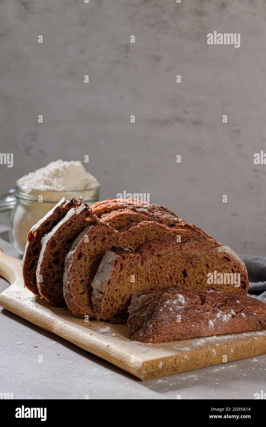 Slices of homemade beetroot bread, and crispy wheat and rye bread. On a ...