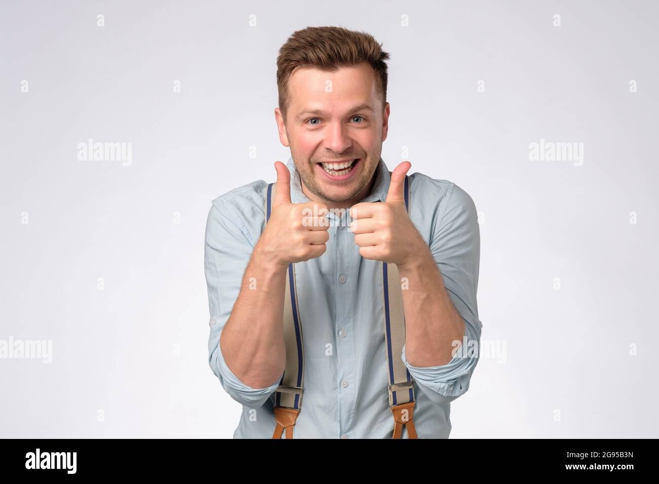 Happy man giving thumbs up sign approving choice Stock Photo - Alamy
