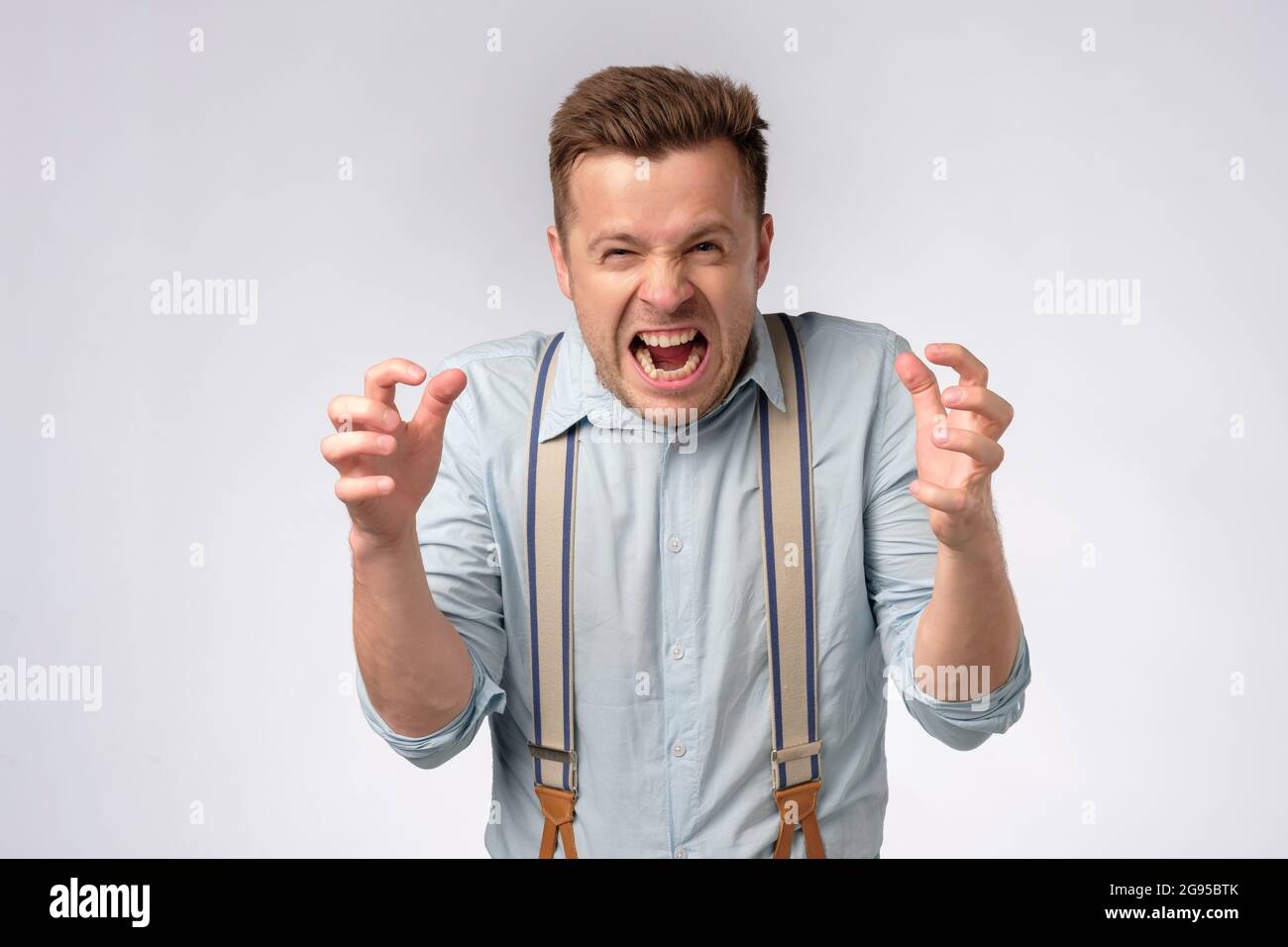 Angry man reacting furious, clenching teeth and hands Stock Photo - Alamy