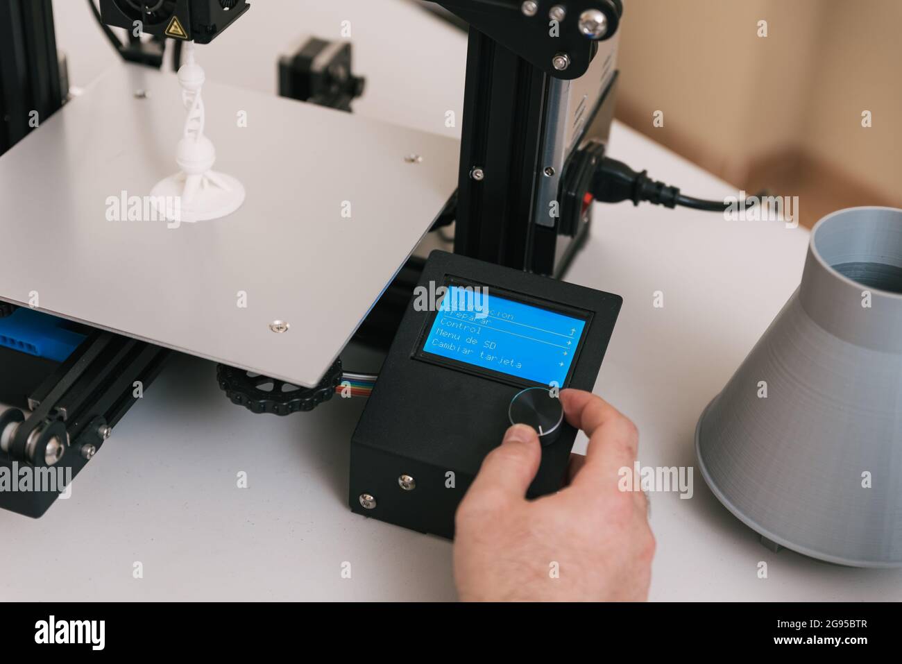 Young engineer in the lab adjusting a 3D printer's components Stock ...