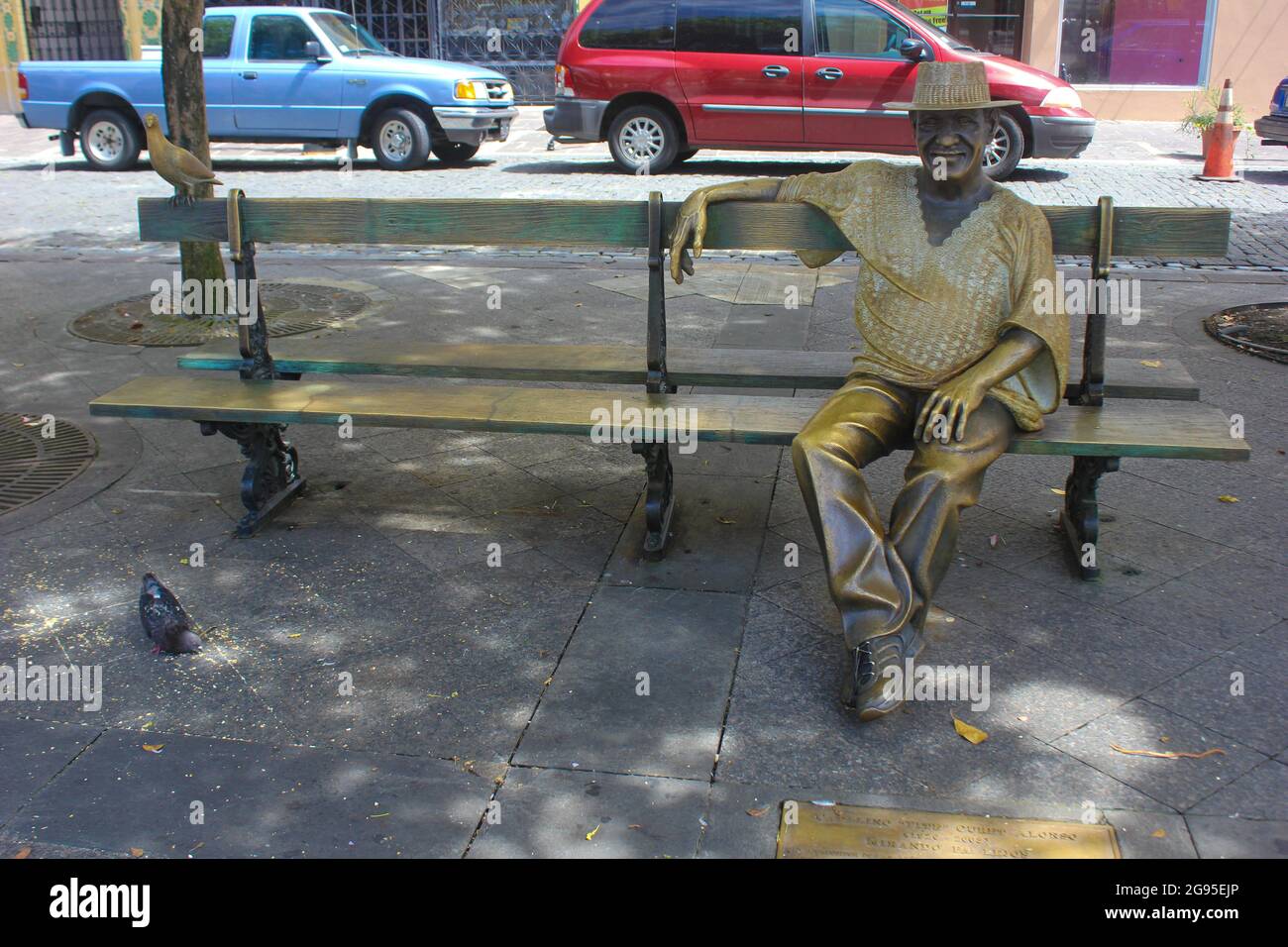 Statue of Puerto Rican composer Tite Curet Alonso sitting on a bench in ...