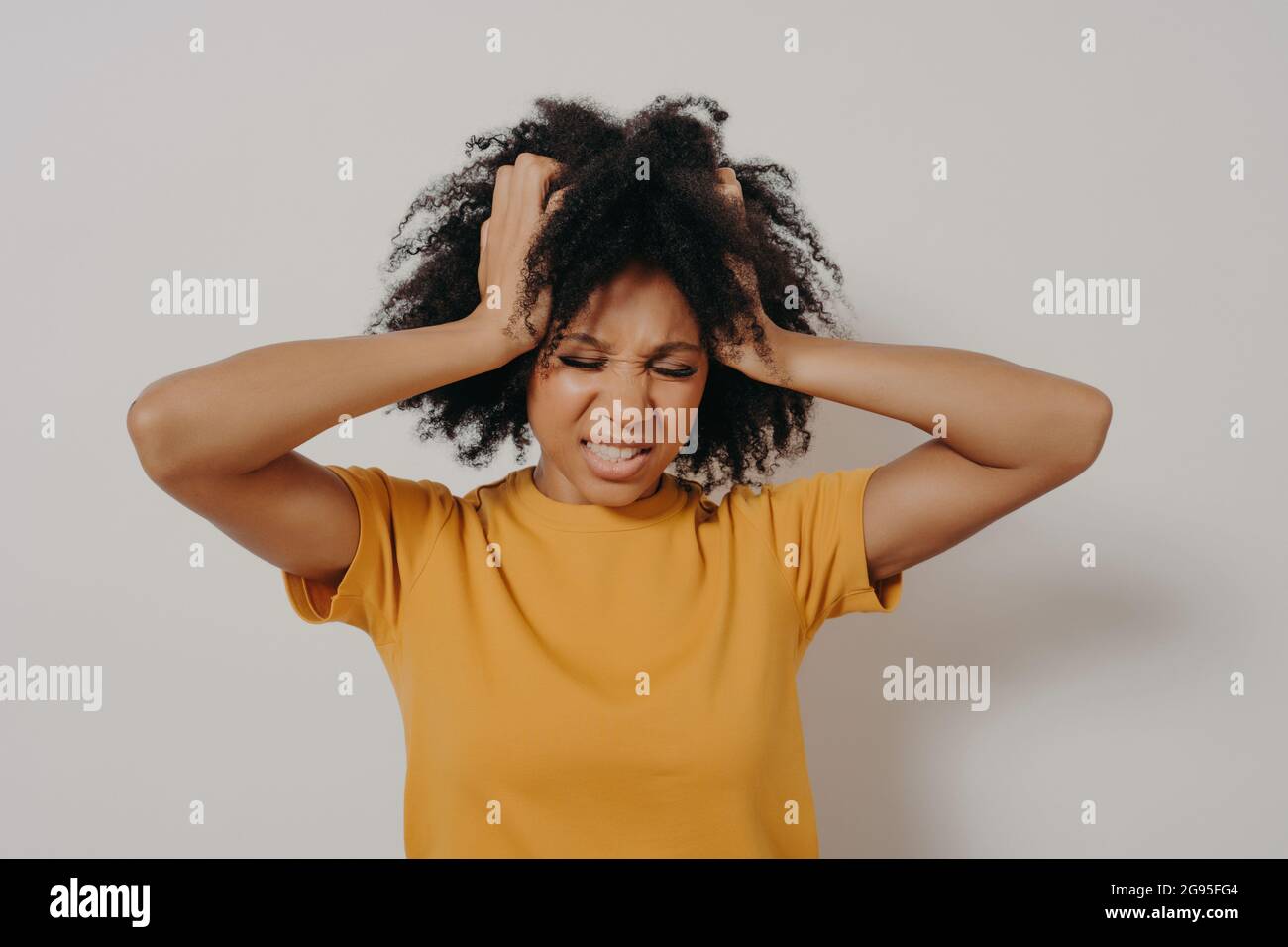Beautiful african young woman standing in casual clothes angry and mad ...