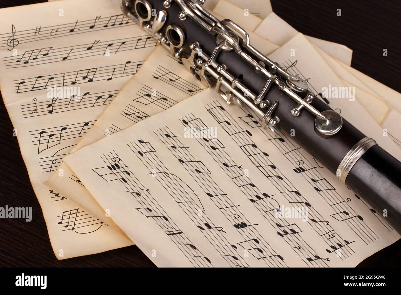 Musical notes and clarinet on wooden table Stock Photo - Alamy
