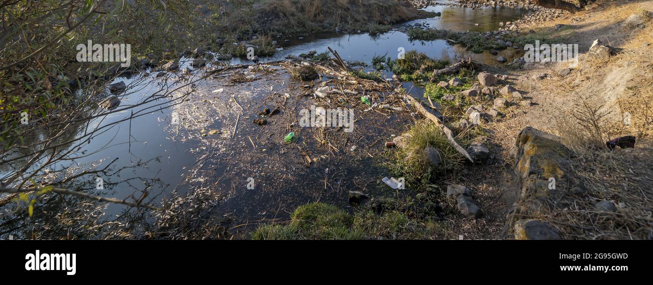 Industrial waste in the river near the field Stock Photo - Alamy