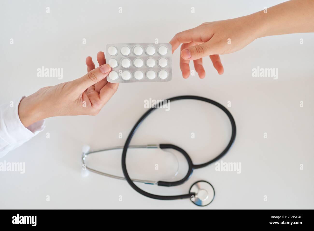 Doctor giving pills patient hi-res stock photography and images - Alamy