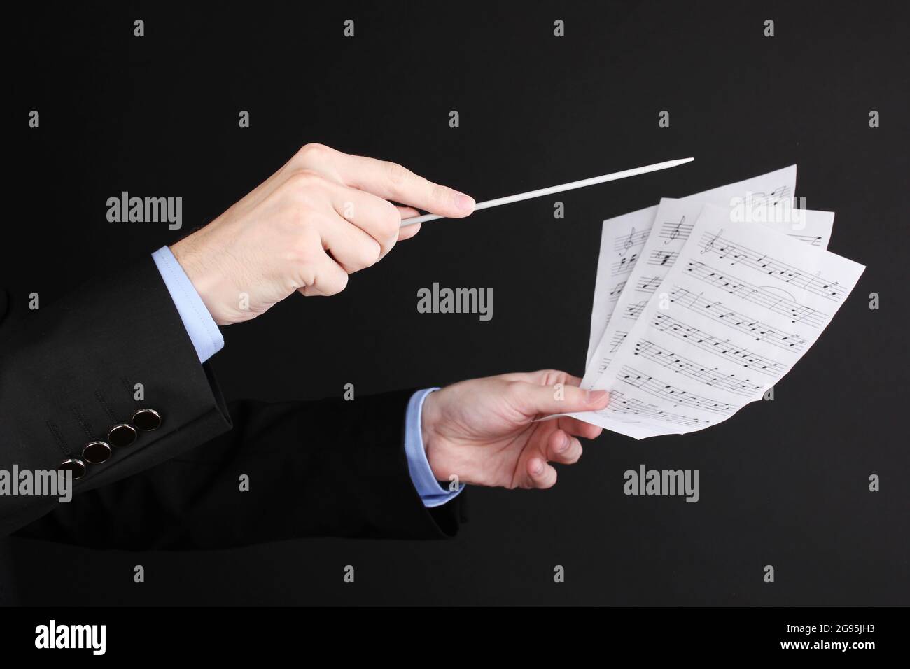Music conductor hands with baton and notes isolated on black Stock ...