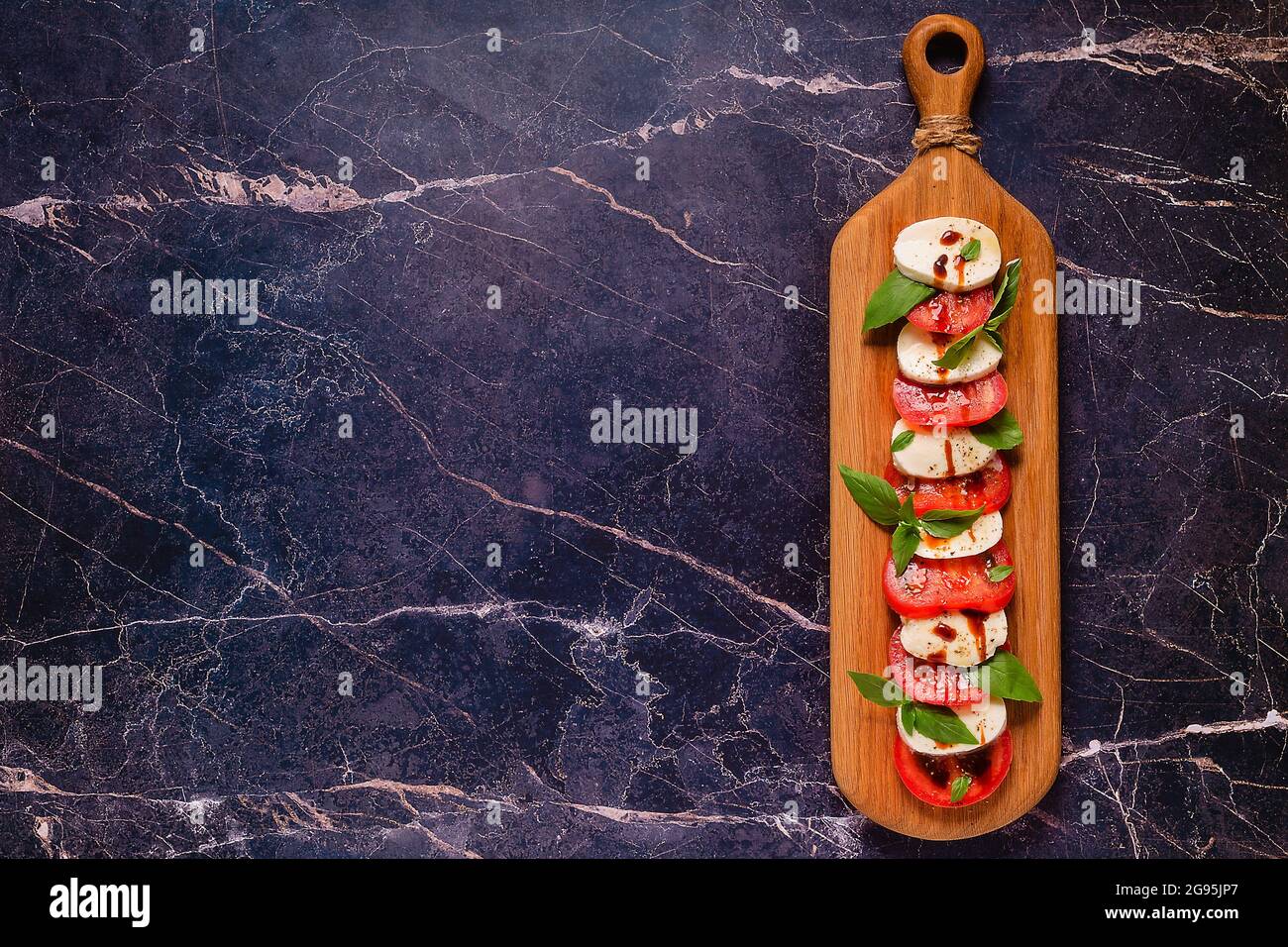 Italian caprese salad with sliced tomatoes, mozzarella, basil, olive ...