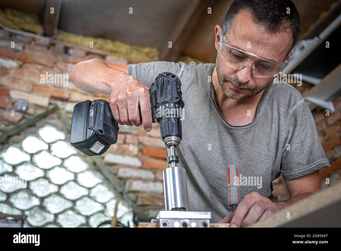 Professional carpenter working with wood and building tools in house ...