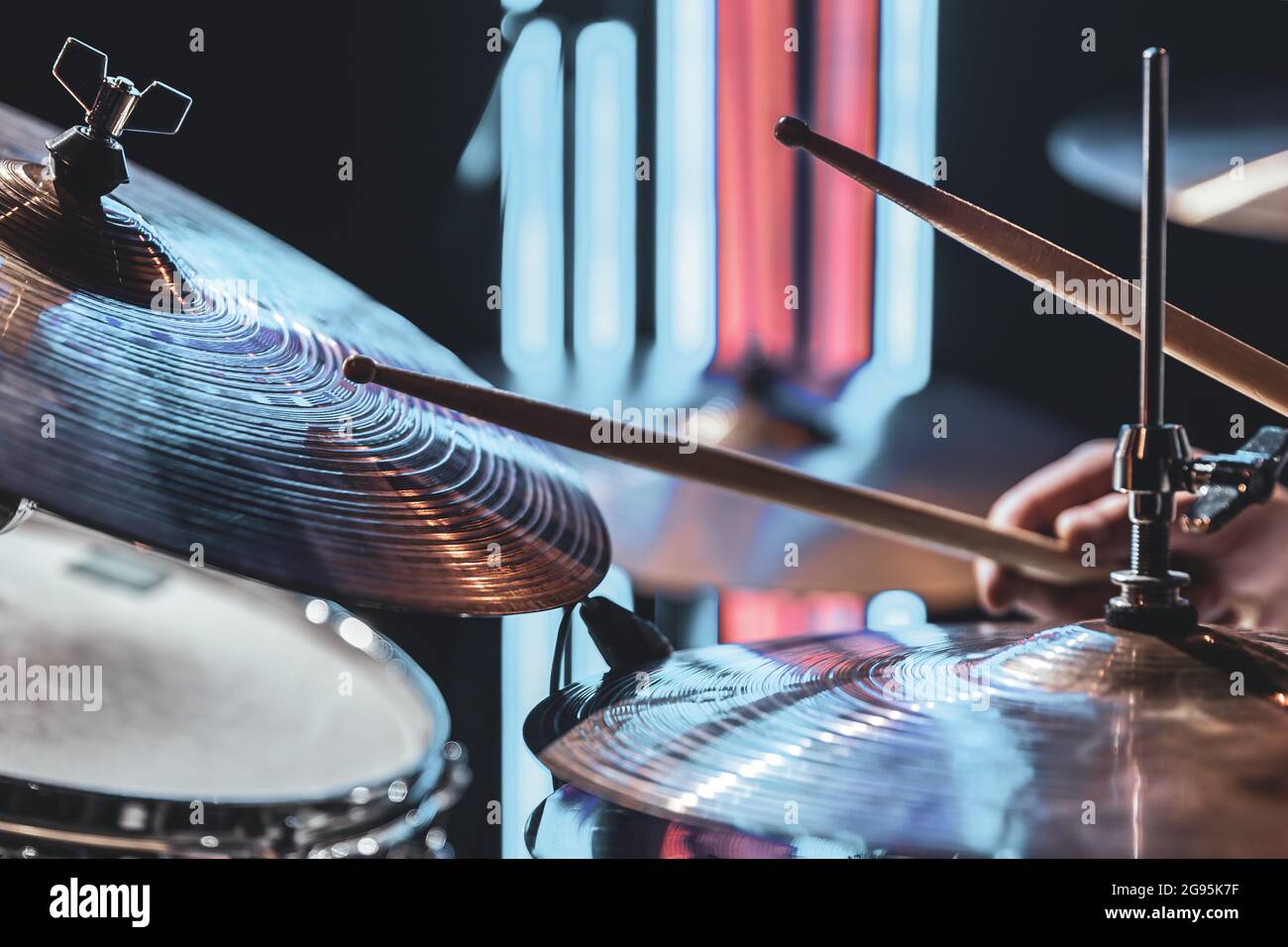 Close-up of drum cymbals as the drummer plays with beautiful lighting ...