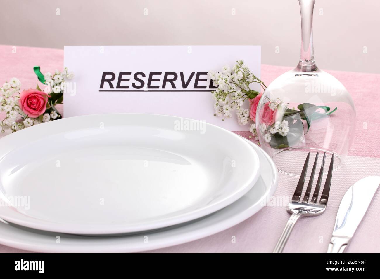 Table setting with reserved card in restaurant Stock Photo - Alamy