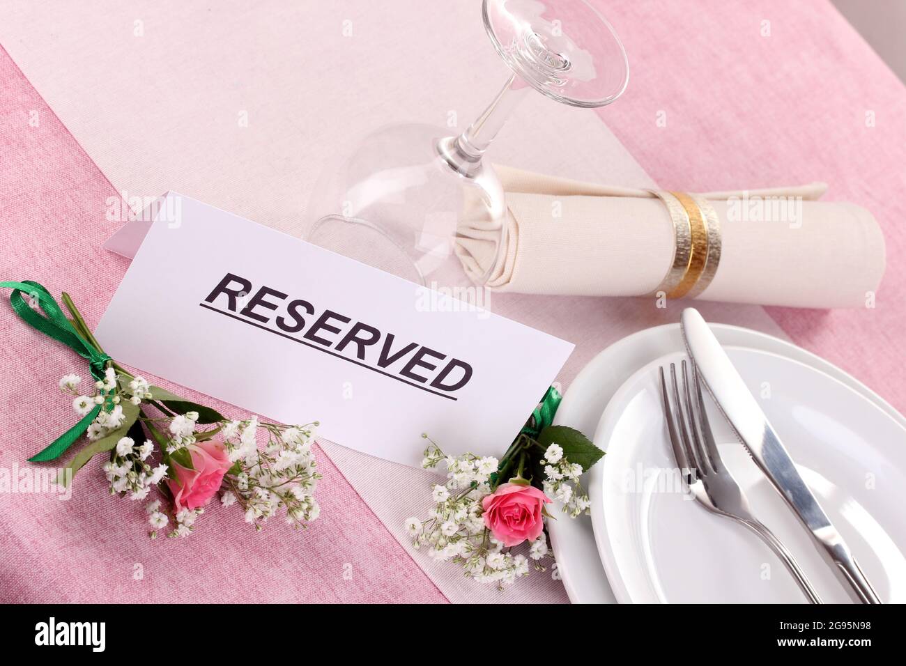 Table setting with reserved card in restaurant Stock Photo - Alamy