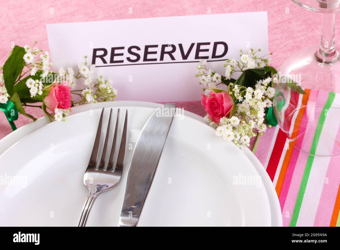 Table setting with reserved card in restaurant Stock Photo - Alamy
