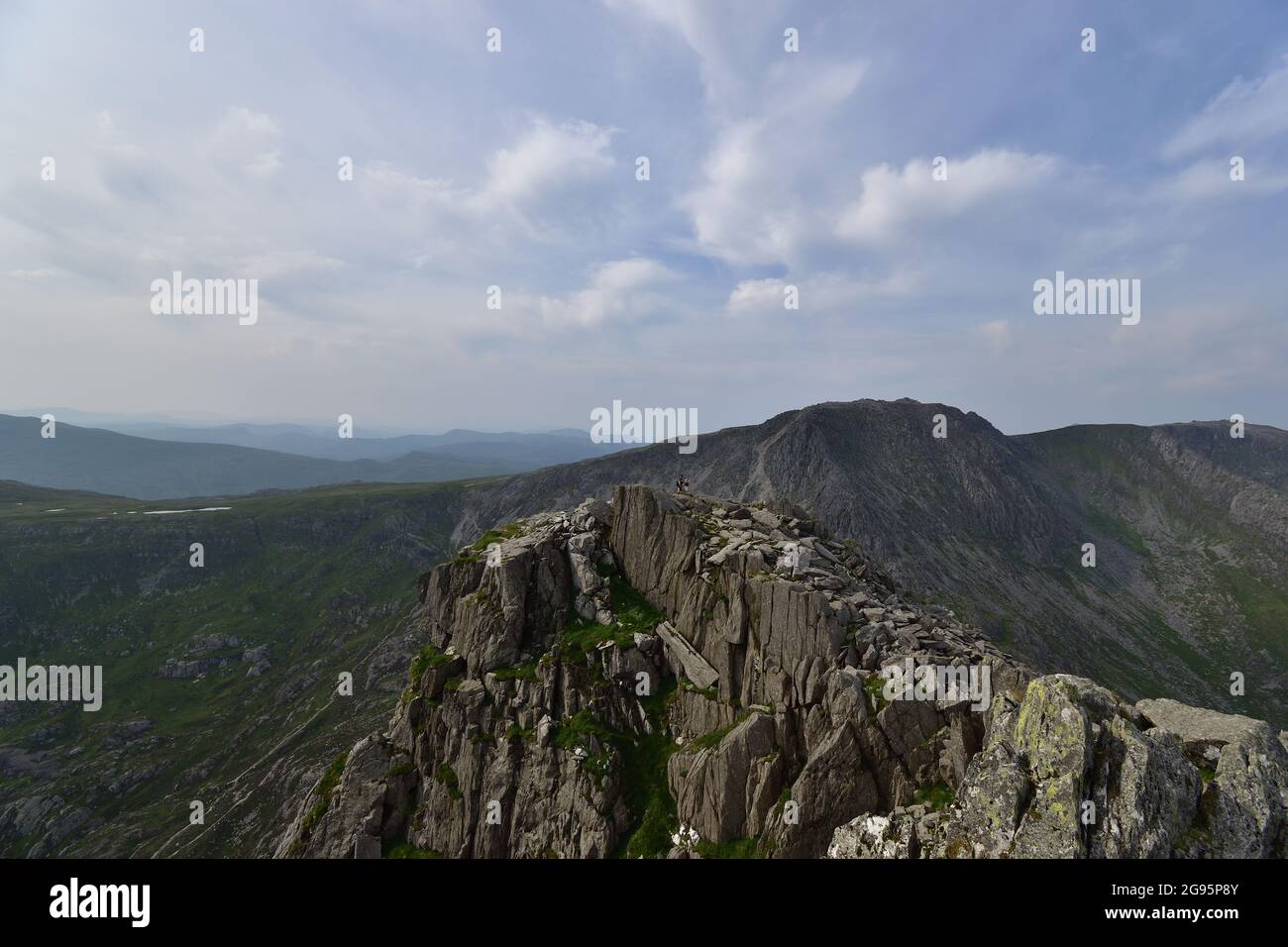 View of Tryfan far south peak with hikers on, taken from Tryfan summit ...