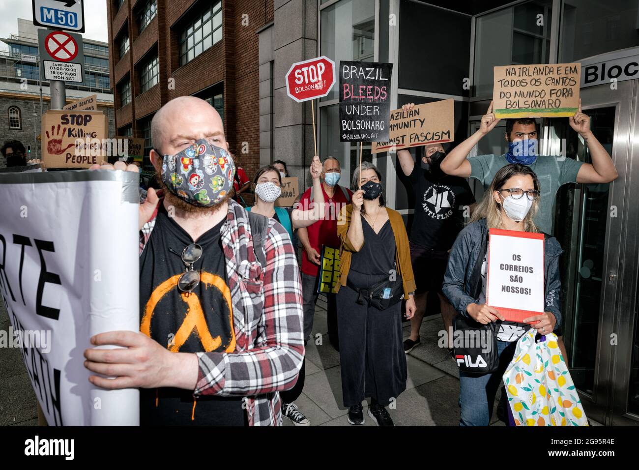 Brazilian protestors hold placards expressing their opinion in front of ...