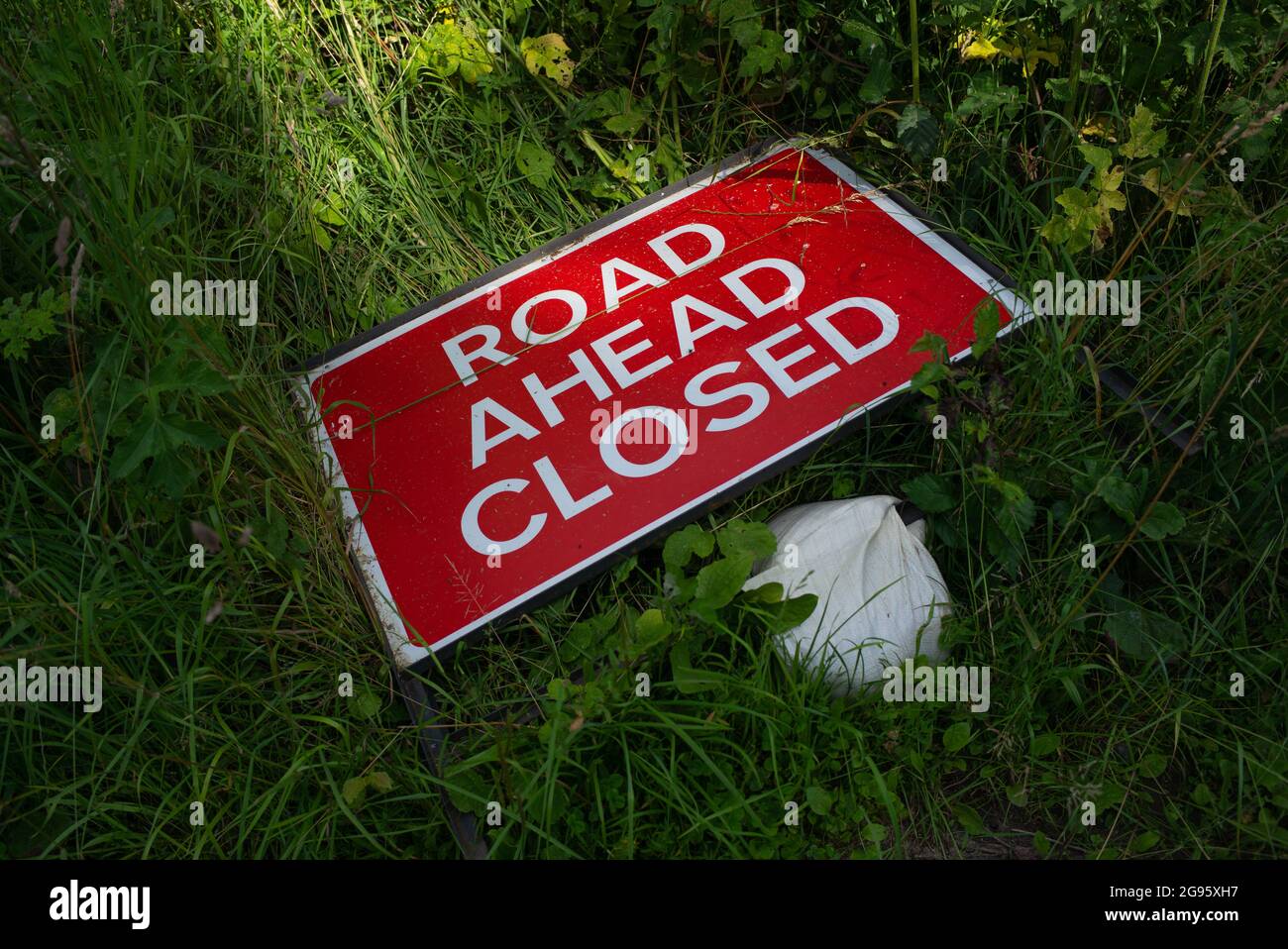 Road Ahead Closed Sign Laid Down At The Roadside Verge To Be Used When road-ahead-closed-sign-laid-down-at-the-roadside-verge-to-be-used-when