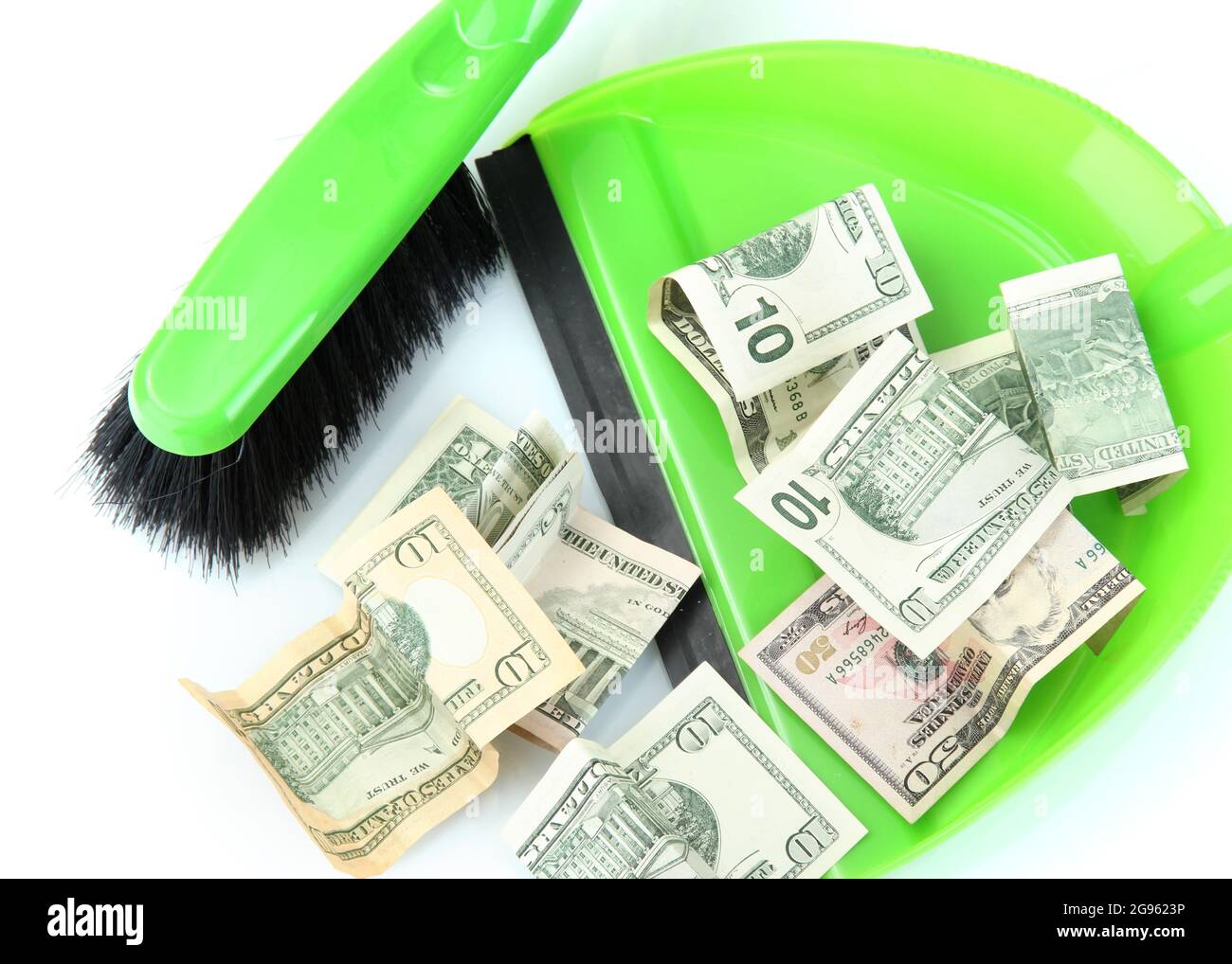 Sweeps money in the shovel on white background close-up Stock Photo - Alamy