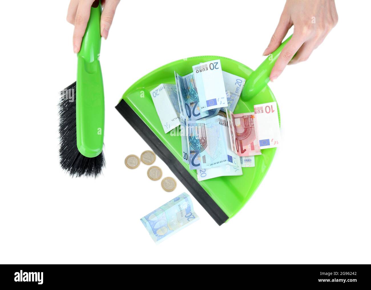 Sweeps money in the shovel on white background close-up Stock Photo - Alamy