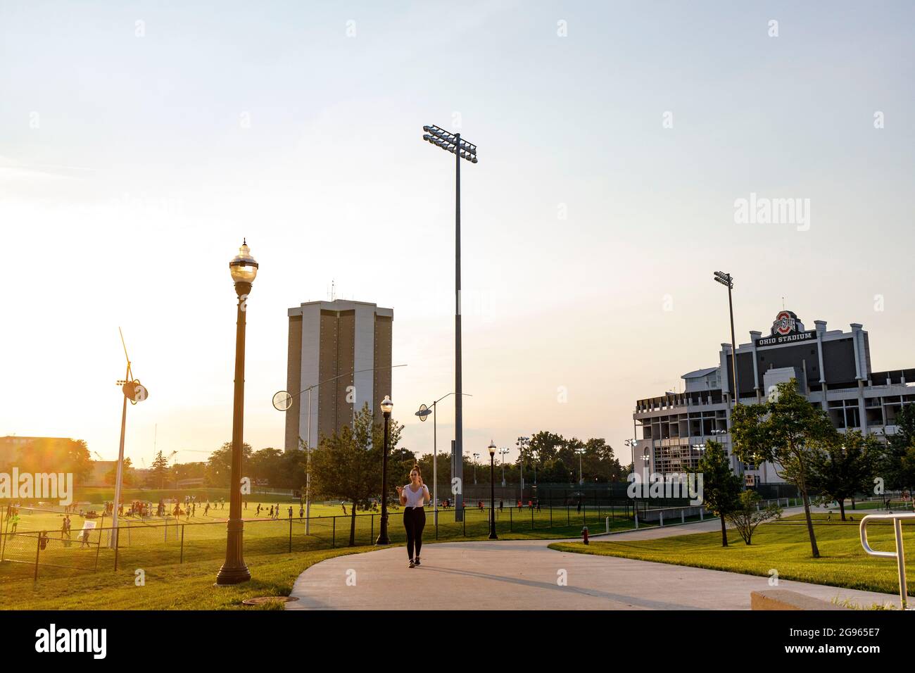 A student walks with the Ohio Stadium in the background, on a summer ...