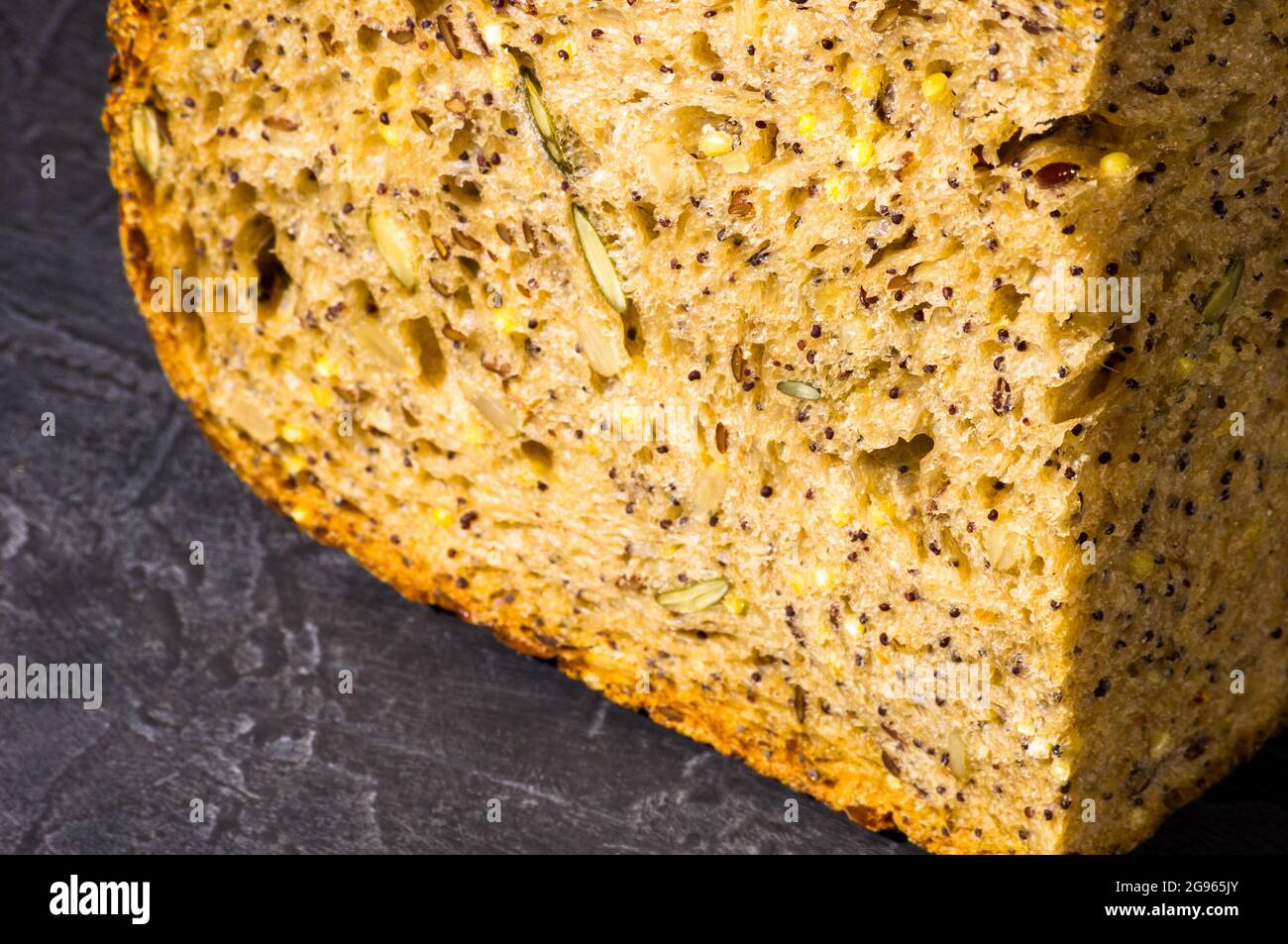 Slice of rustic natural yeast-free bread with flax, poppy seeds, sesame ...