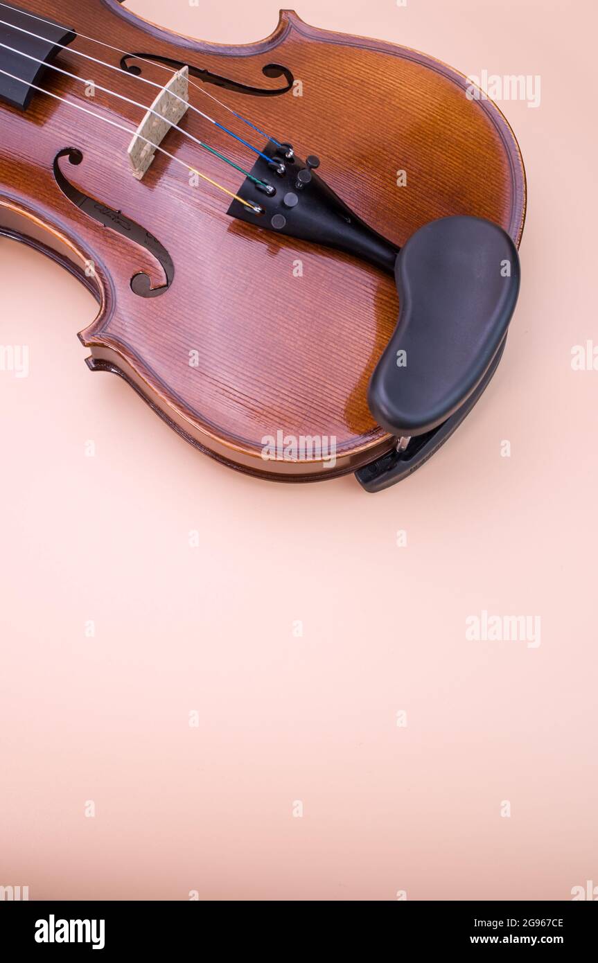 Vertical shot of violin isolated on light pink background Stock Photo ...