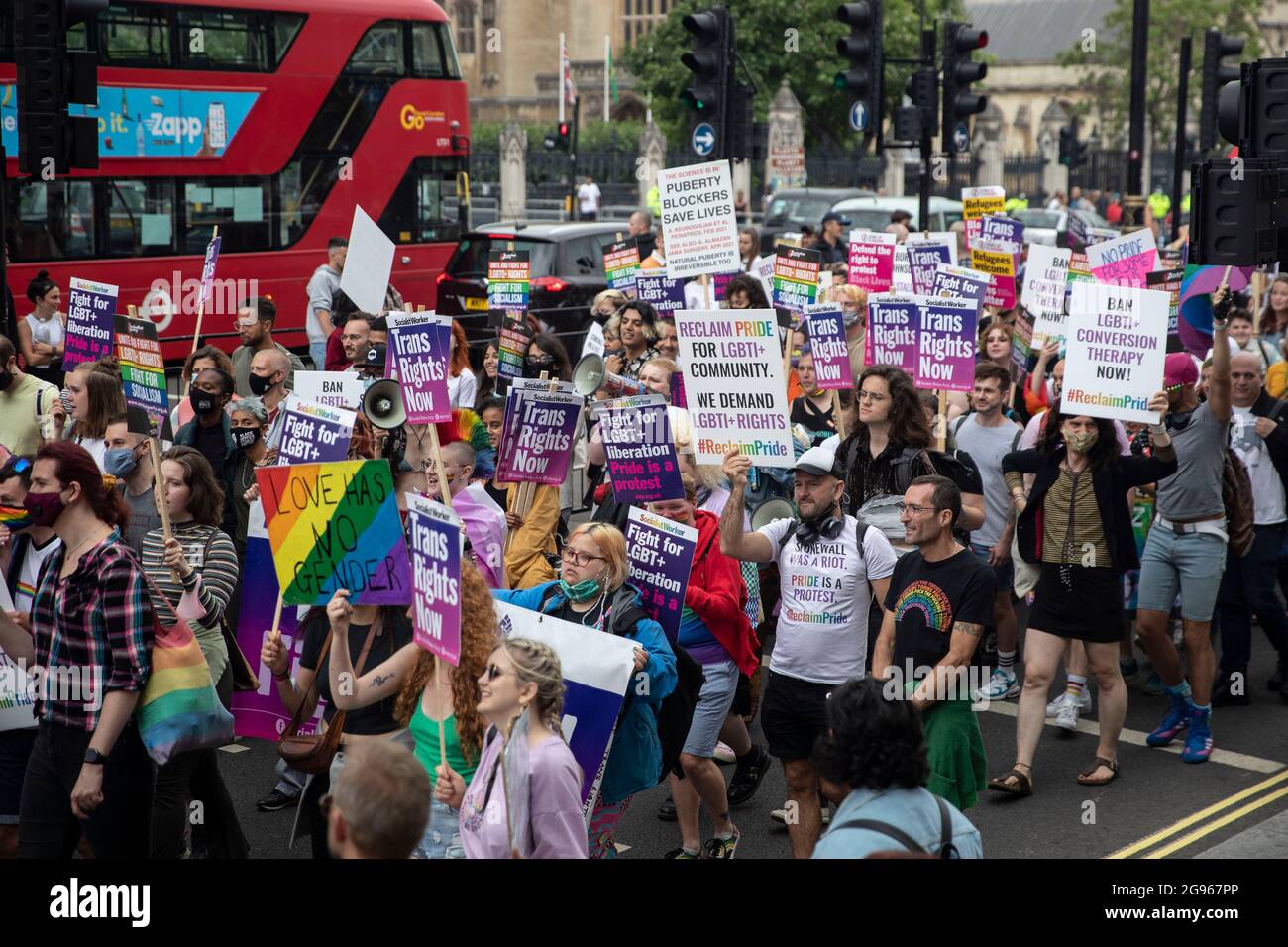 London, UK. 24th July, 2021. LGBT activists holds placards while ...
