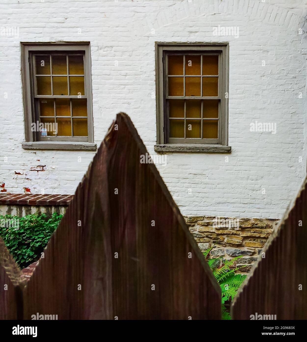 Wooden fence, windows, brick sidewall at Charles Demote art gallery and ...
