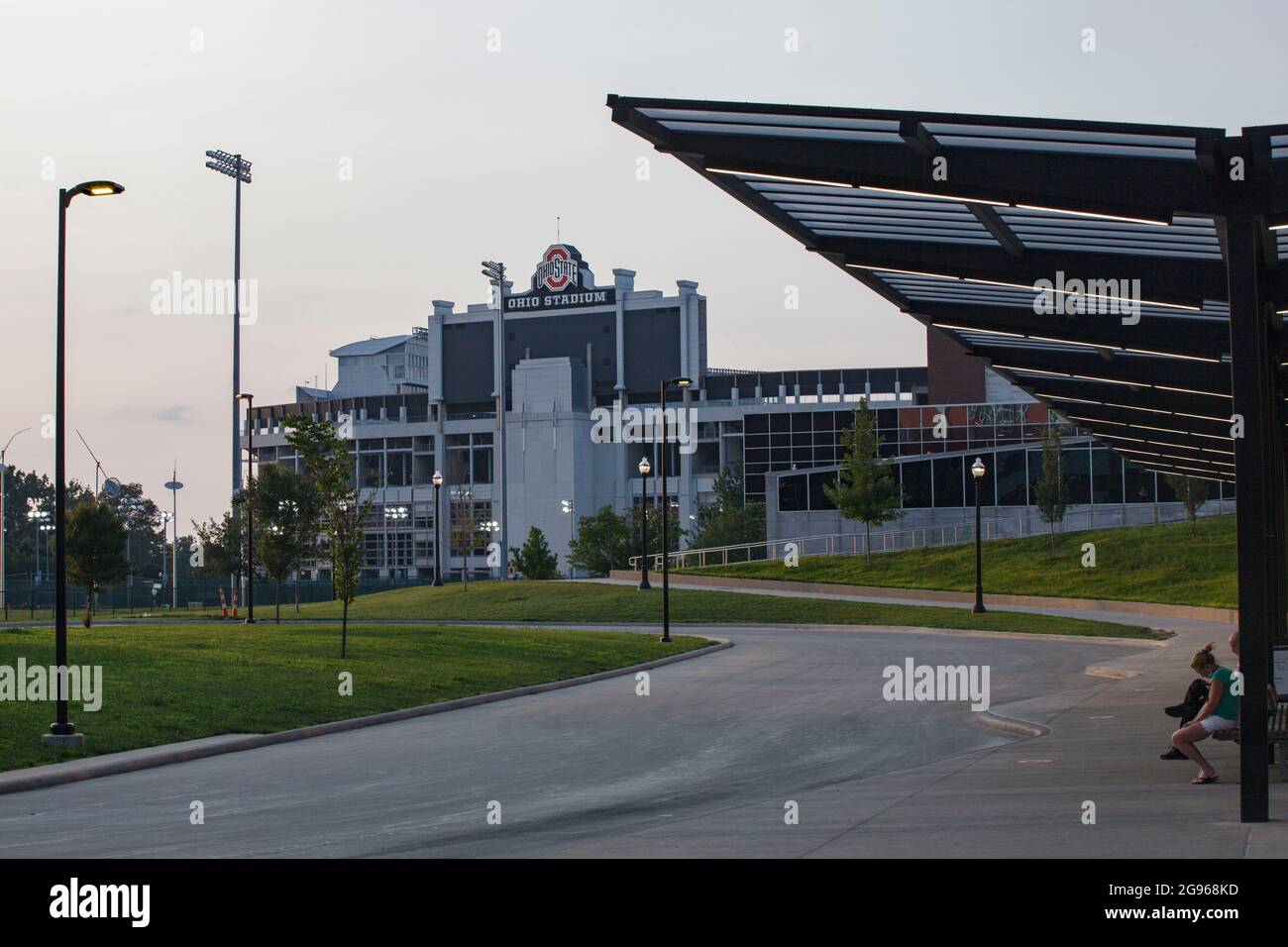 People wait for The Ohio State University buses at a bus stop with the ...