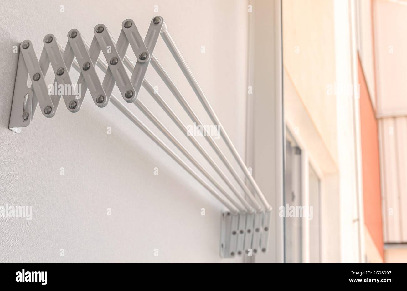Modern clothes hanger on balcony, housework concept background Stock ...