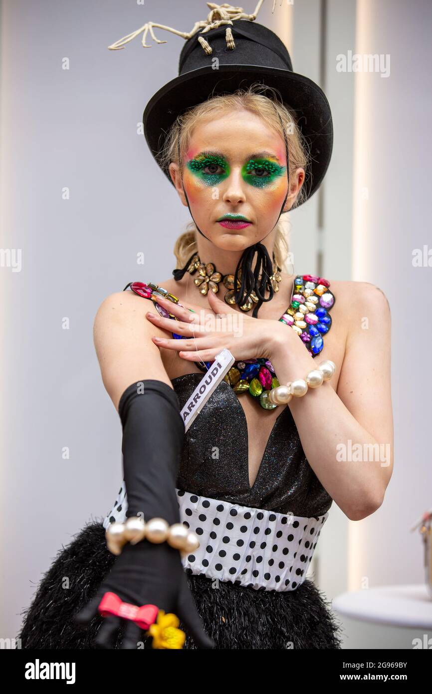 A model showcases Pierre Garroudi's latest colourful collection at one ...