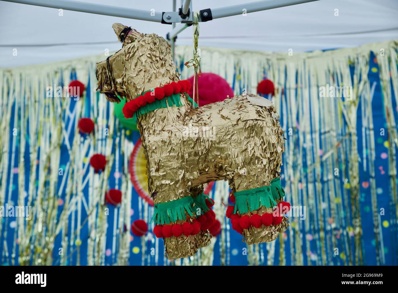 Closeup of a colorful pinata hanging from a ceiling during a party ...