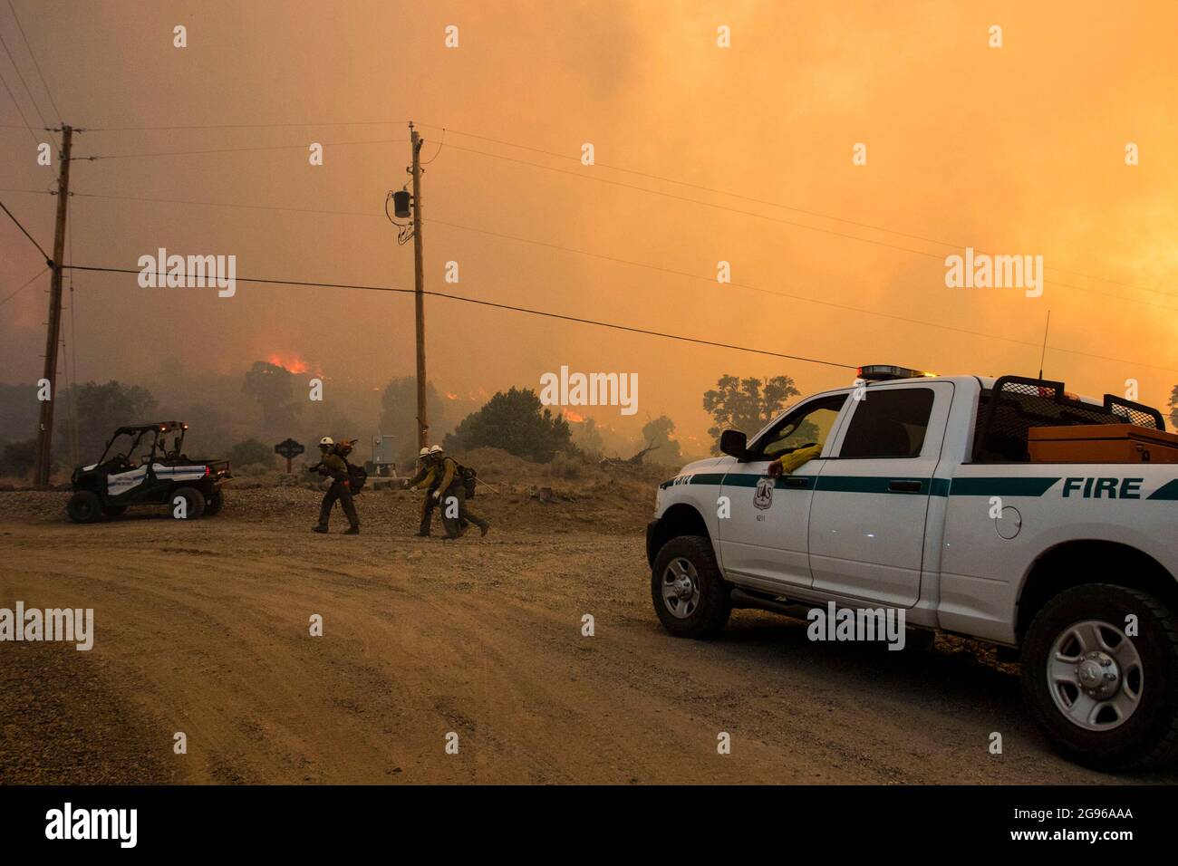 Fire crews work to contain the Tamarack fire as it encroaches on homes ...