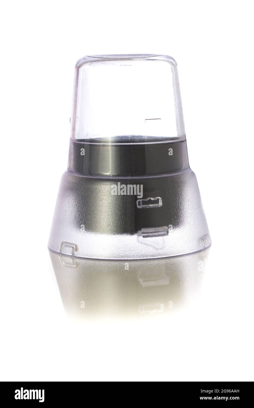 Vertical shot of a miller blender attachment on a reflective surface ...