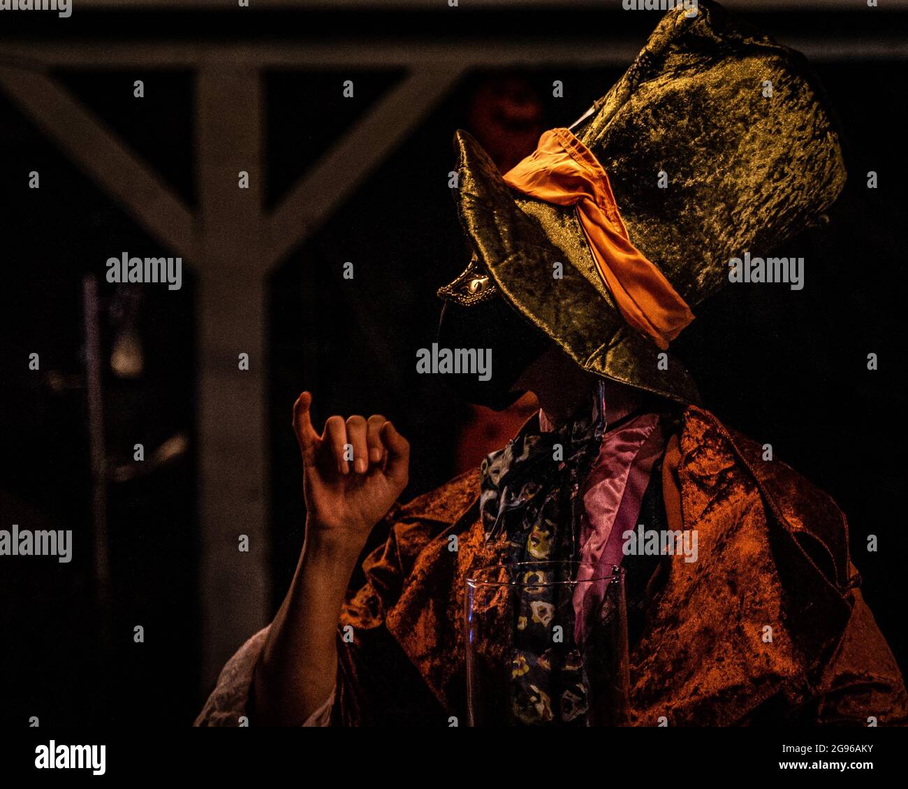 Selective focus of a person in a mysterious costume and doing a hand ...