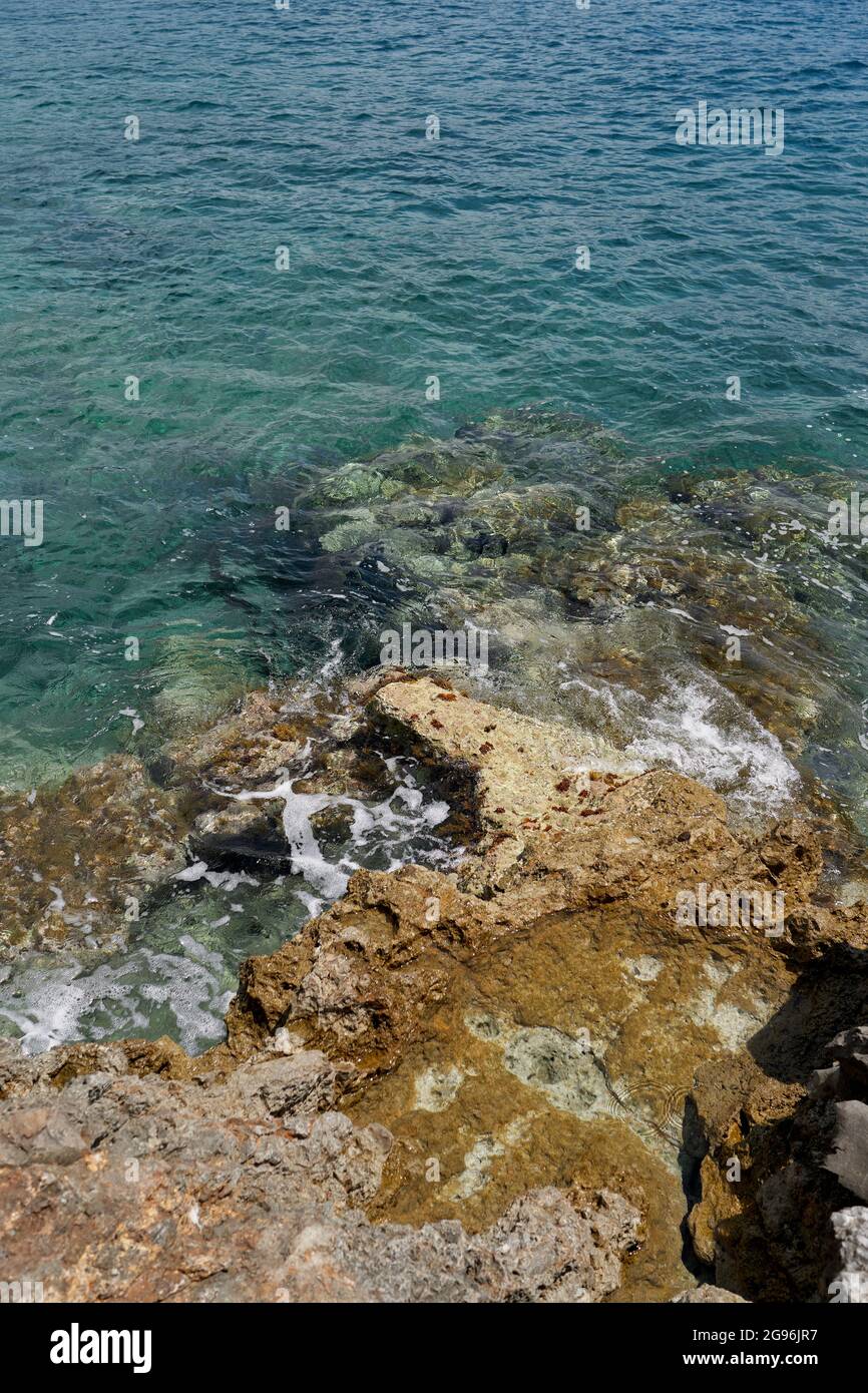 Large stone ledges rising from the sea water Stock Photo - Alamy