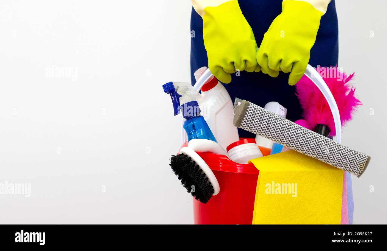 House cleaning products pile in hand with green gloves on white ...
