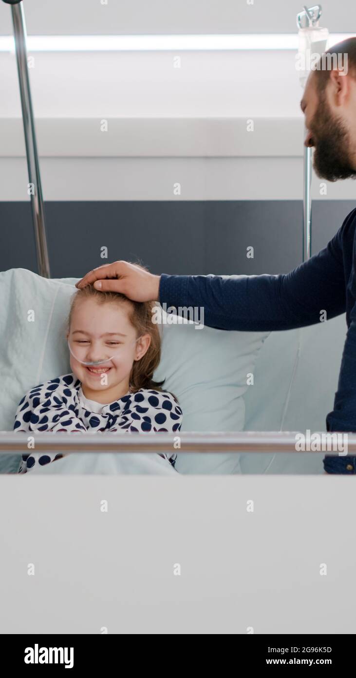 Happy family giving high five to little girl daughter recovering after ...