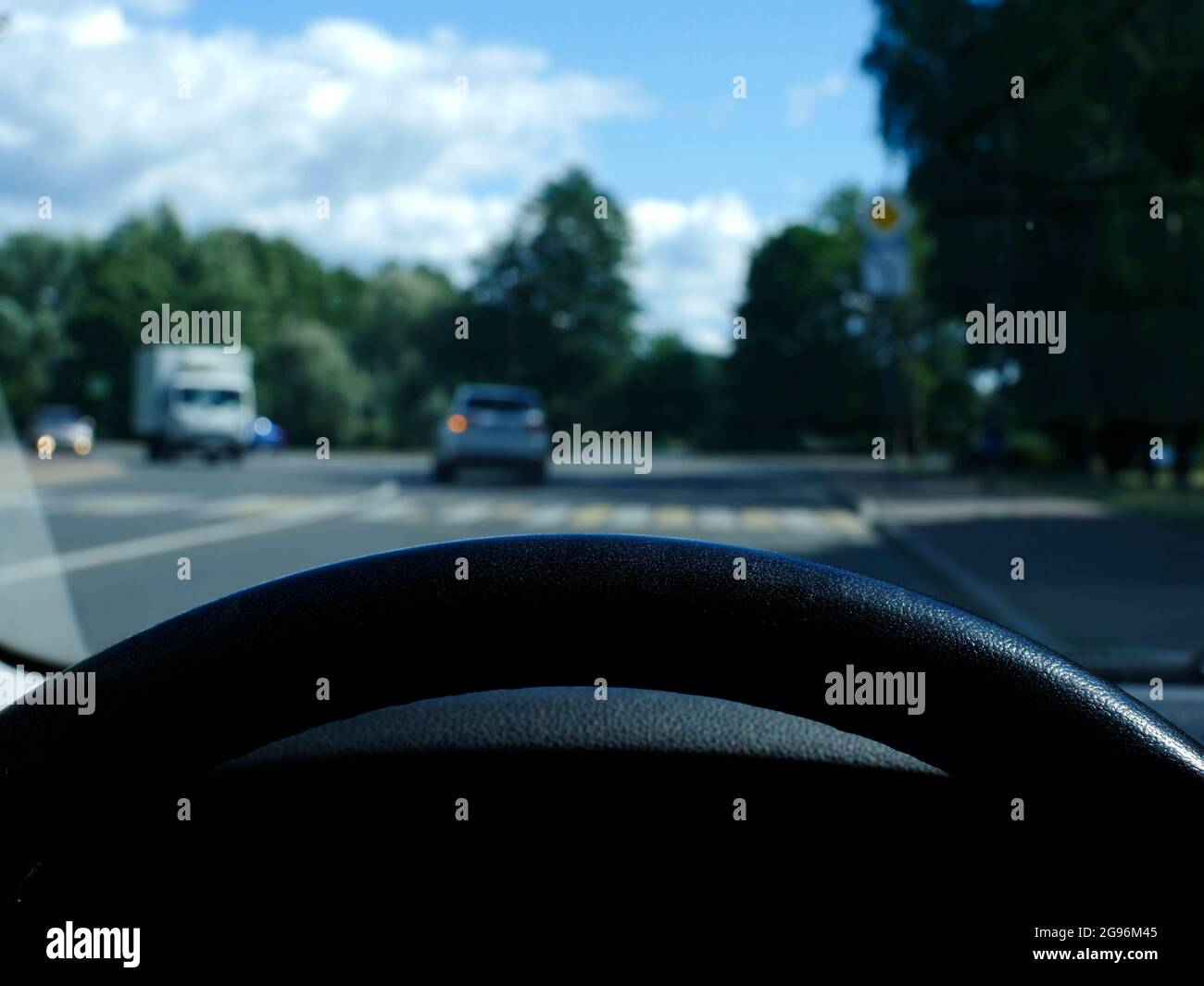view from behind the steering wheel of a car first-person view Stock ...
