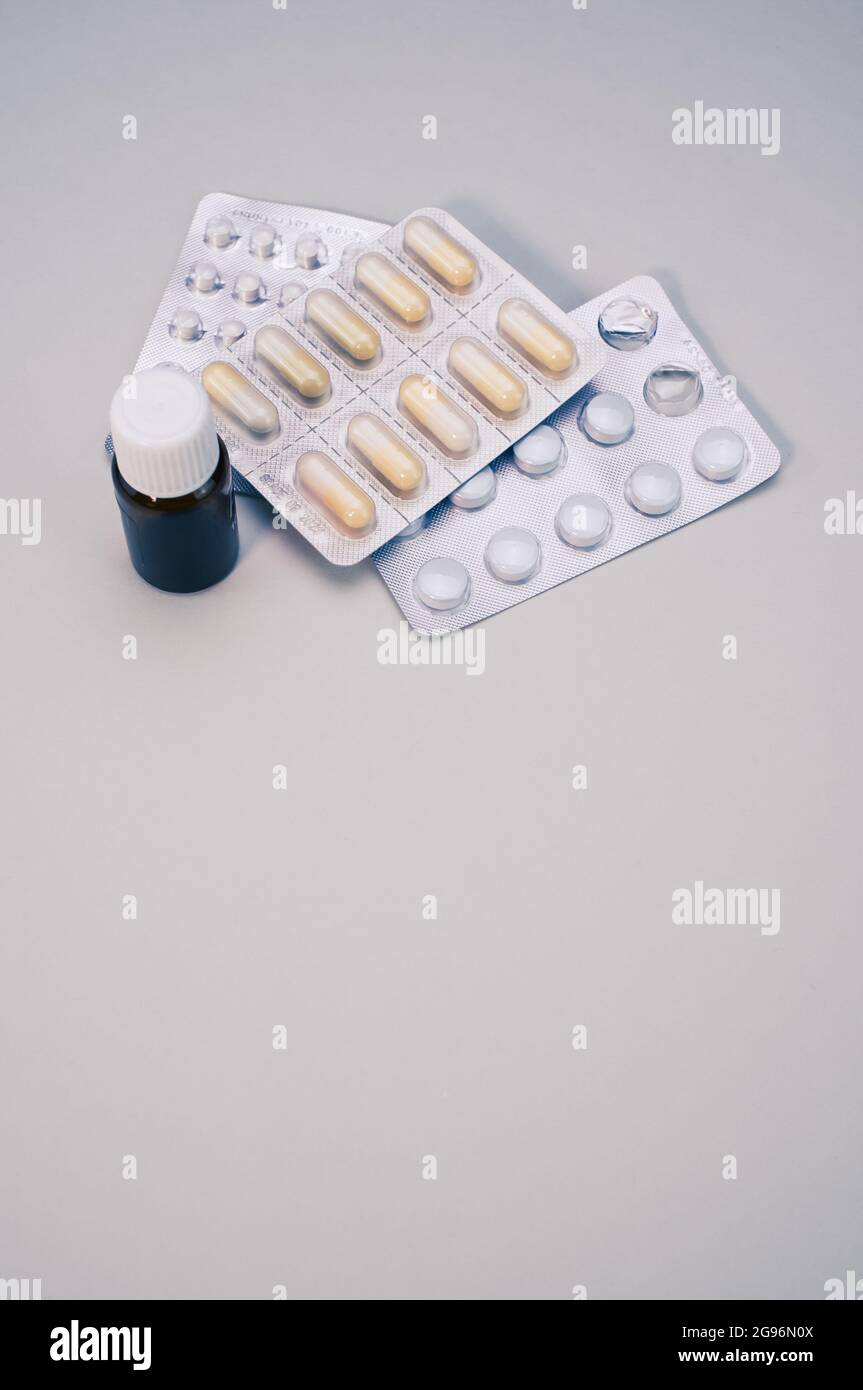 Vertical shot of medicine bottle and tablets isolated on white ...