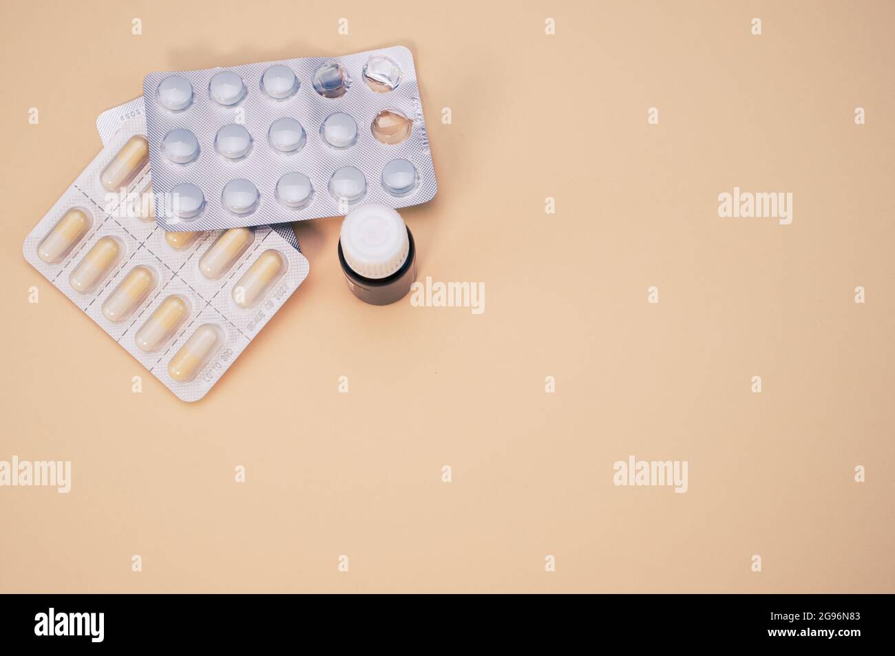 Top view of medicine bottle and tablets isolated on light brown ...
