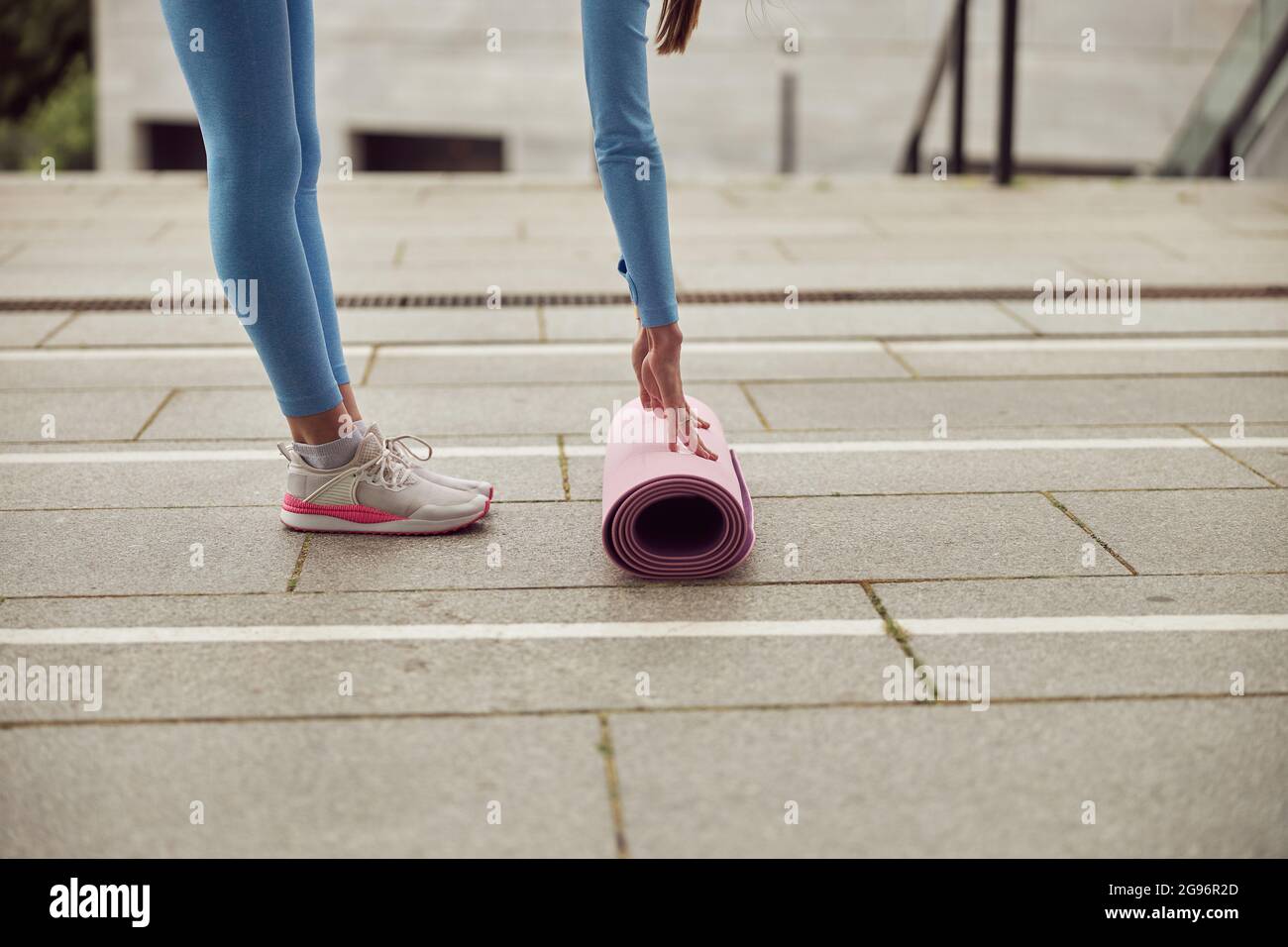 Young fit lady is doing fitness and jogging at urban place Stock Photo ...