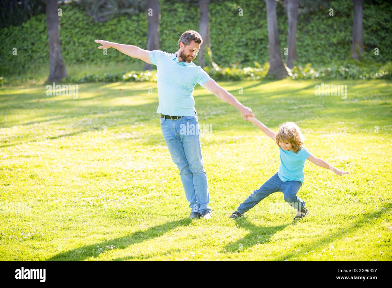 Happy boy child pull fathers hand playing on summer outdoors, fun Stock ...