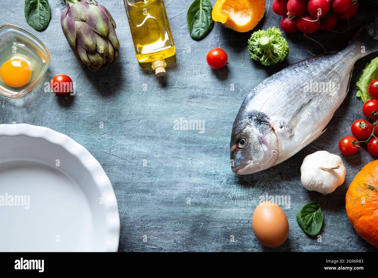Food ingredients on black grunge background with a white dish Stock ...