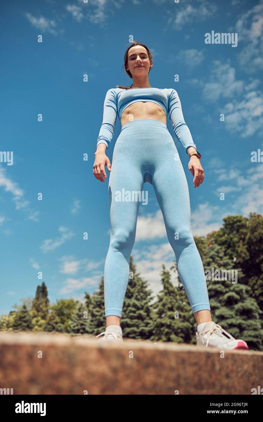 Beautiful fit young woman jogger is running outdoors Stock Photo - Alamy