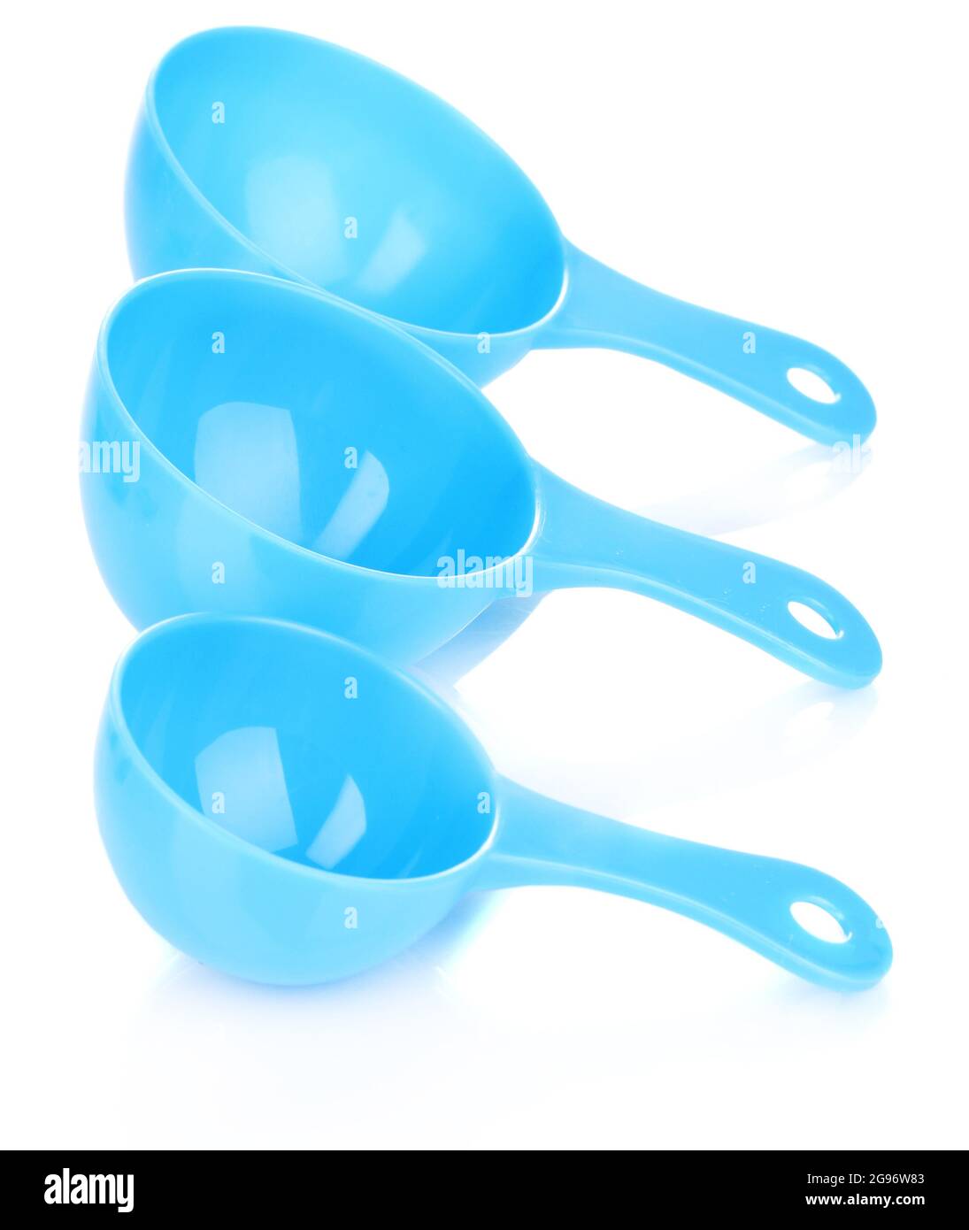 Blue measuring spoons isolated on white Stock Photo - Alamy