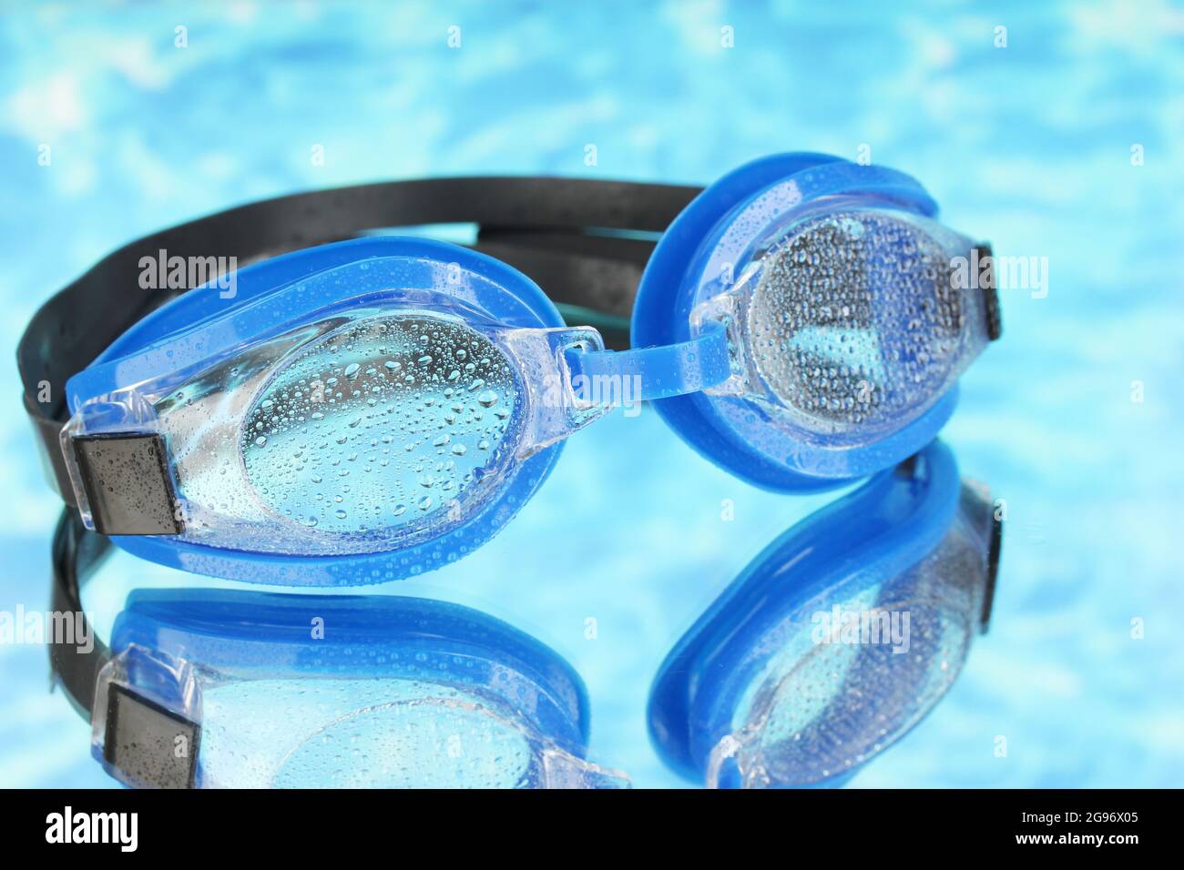 blue swim goggles with drops on blue sea background Stock Photo - Alamy