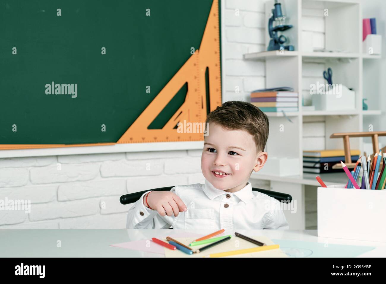 Homeschooling. Schoolboy boy studies at home and does preschool ...