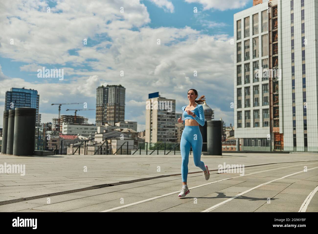 Beautiful fit young woman jogger is running outdoors Stock Photo - Alamy