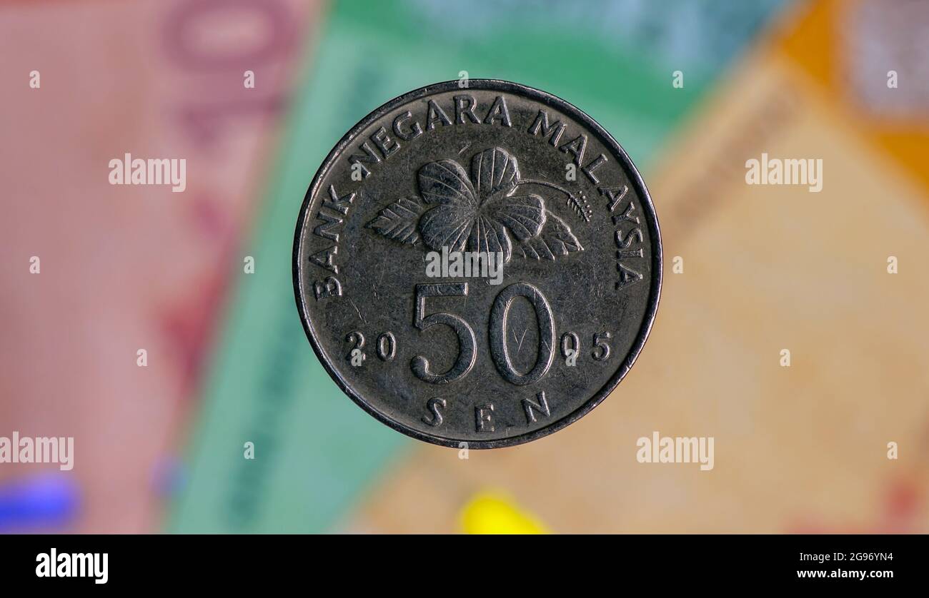 Money, 50 sen coins on blurred background of Ringgit Malaysia banknote ...