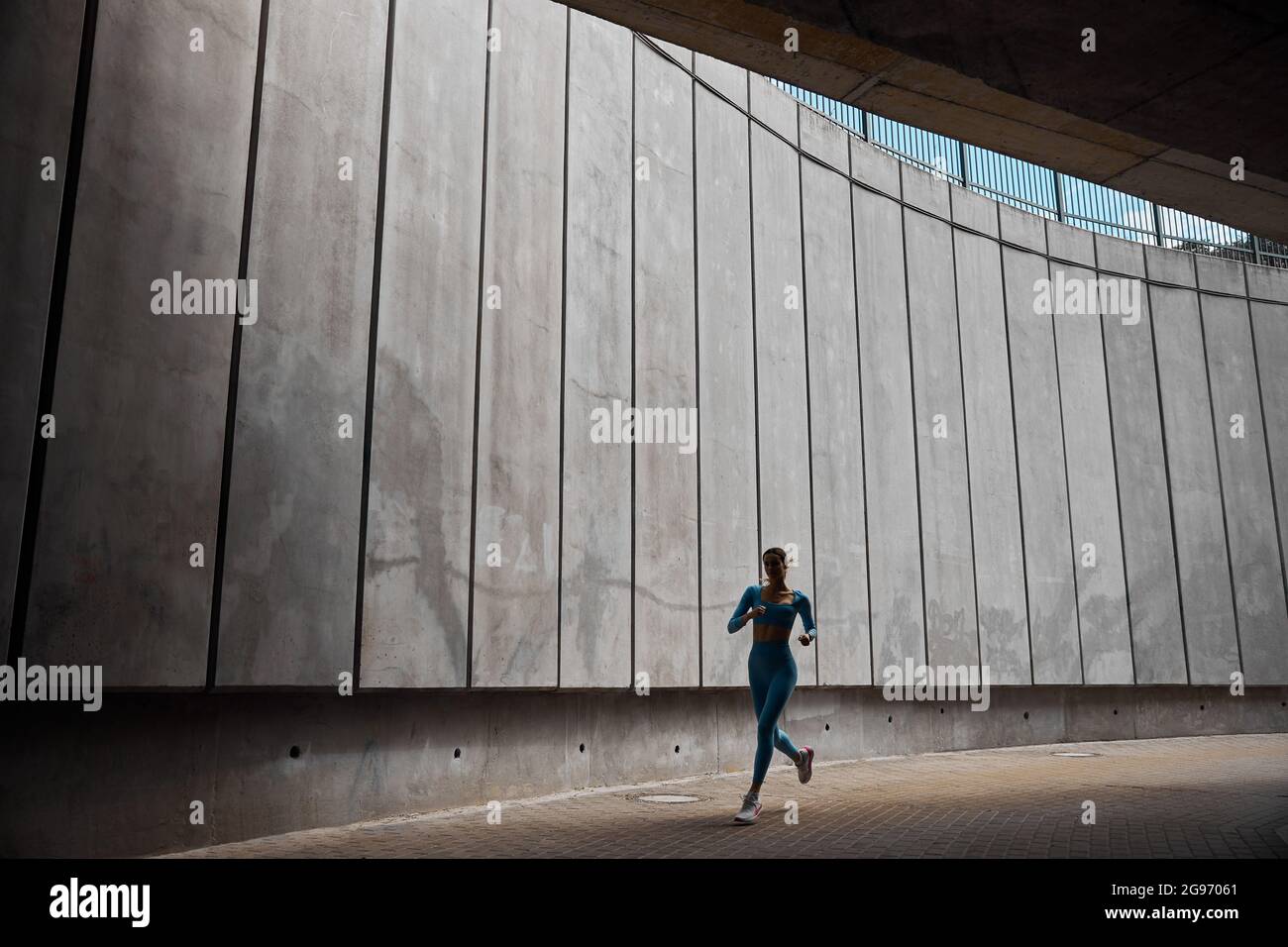Beautiful fit young woman jogger is running outdoors Stock Photo - Alamy