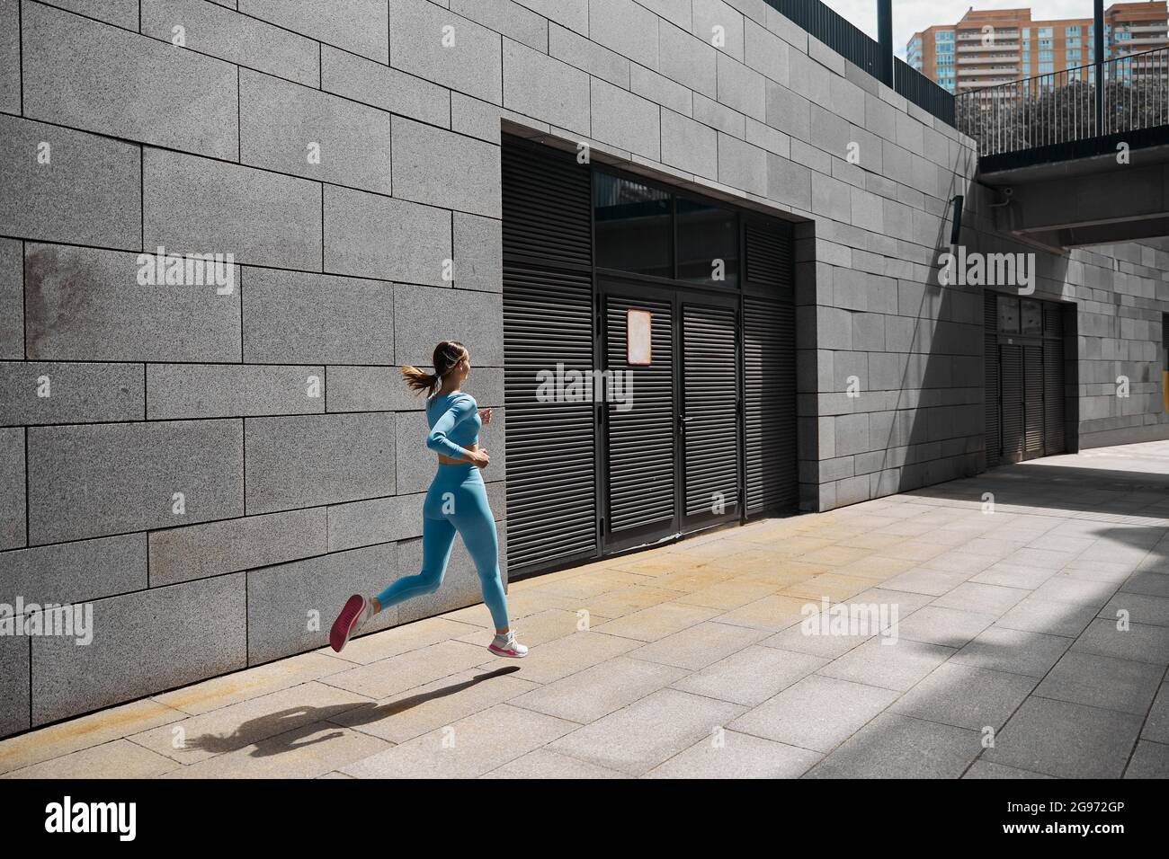 Beautiful fit young woman jogger is running outdoors Stock Photo - Alamy